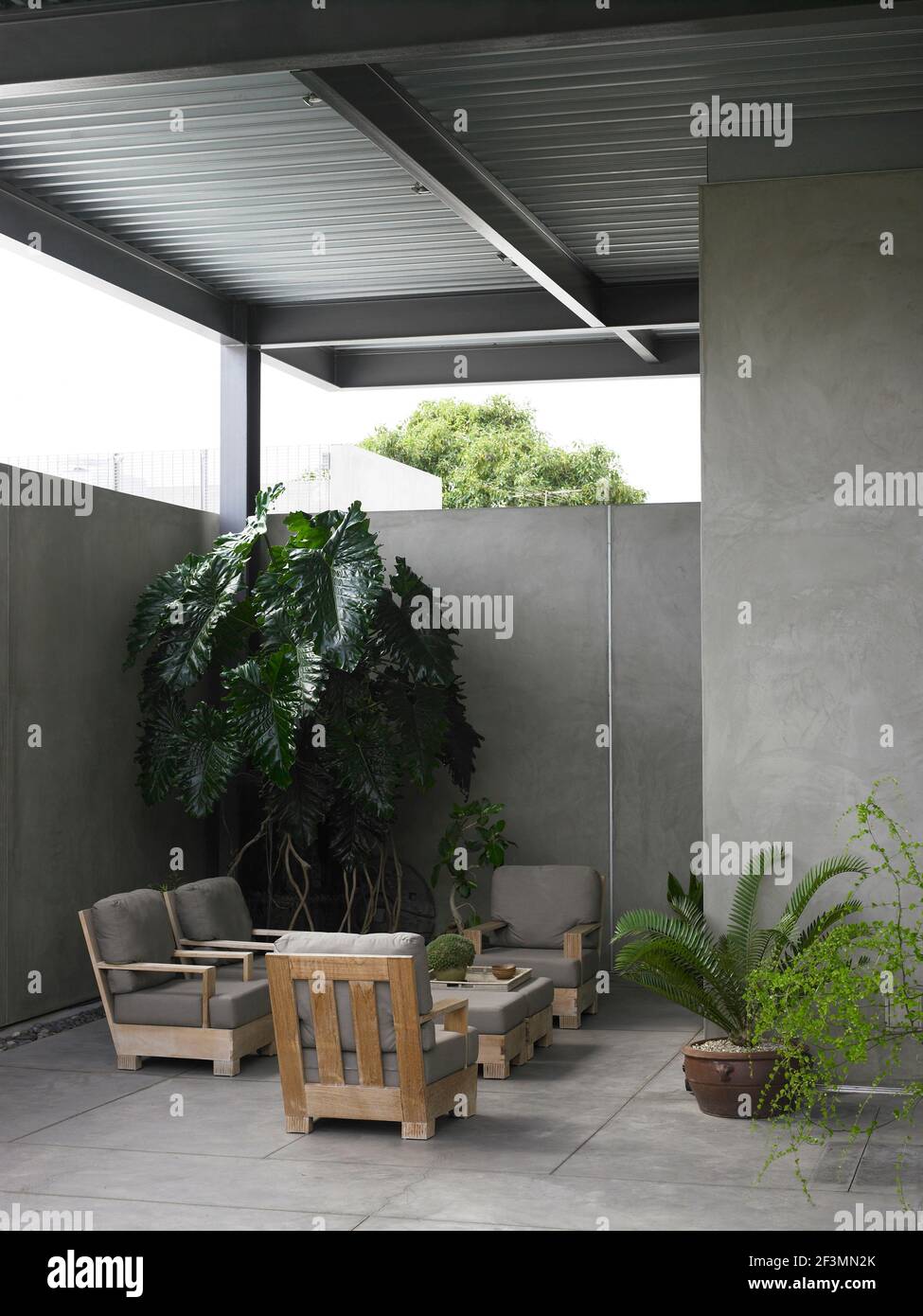 Seating on shaded patio in USA home Stock Photo - Alamy