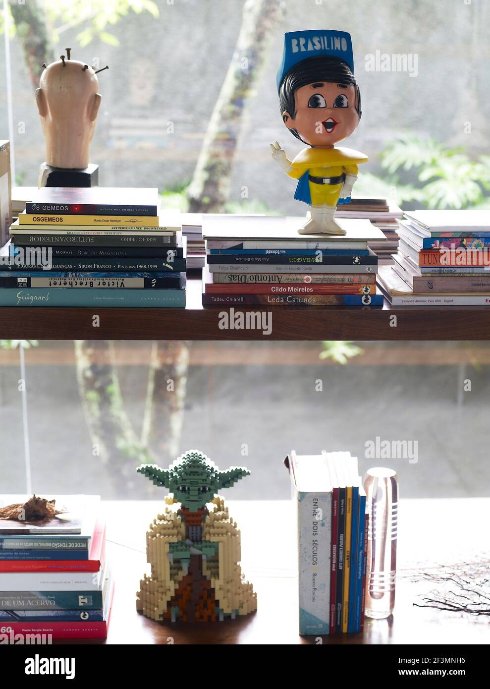 Collection of books and kitsch on wooden shelf in Brazilian home Stock ...