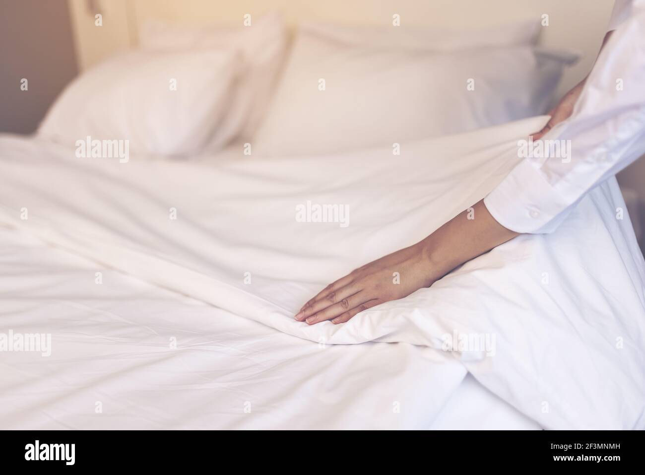 Room maid making up bed hi-res stock photography and images - Alamy