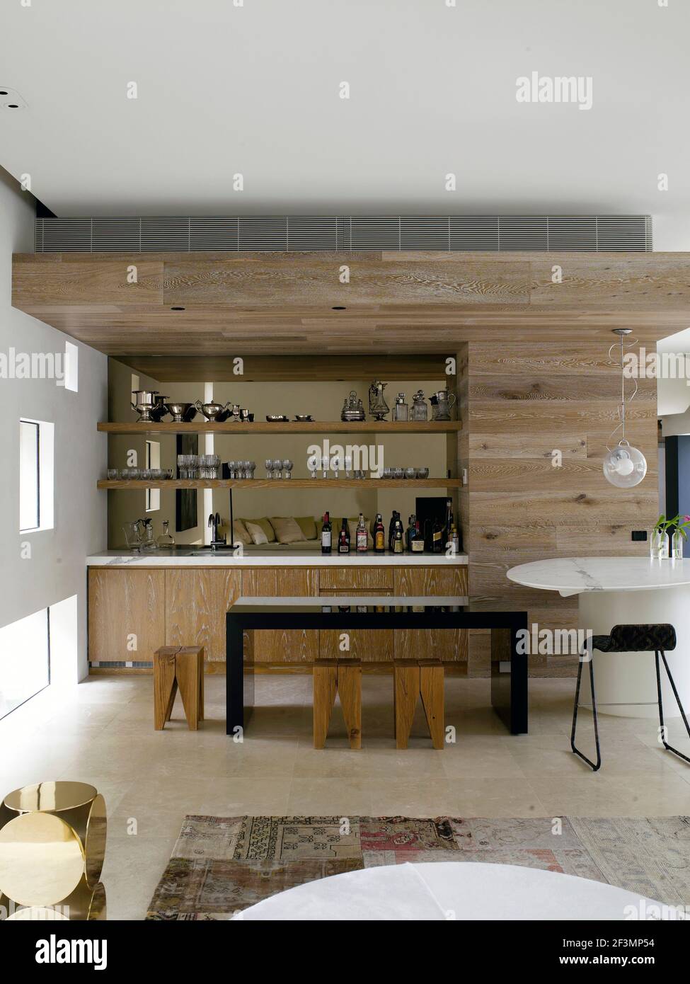 Table and breakfast bar in open plan kitchen area in Australian home ...