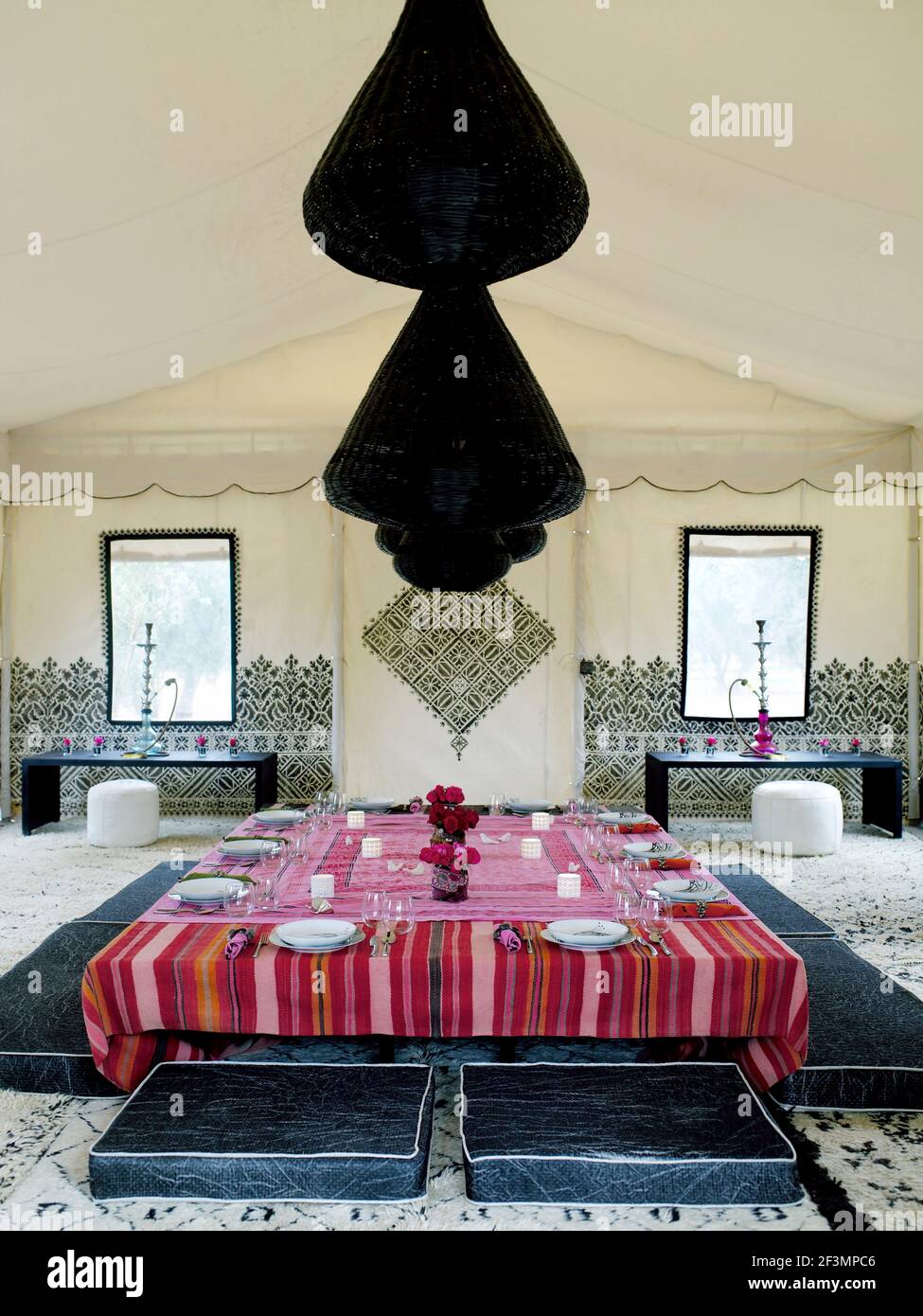 Cushions around low table in Moroccan home Stock Photo - Alamy