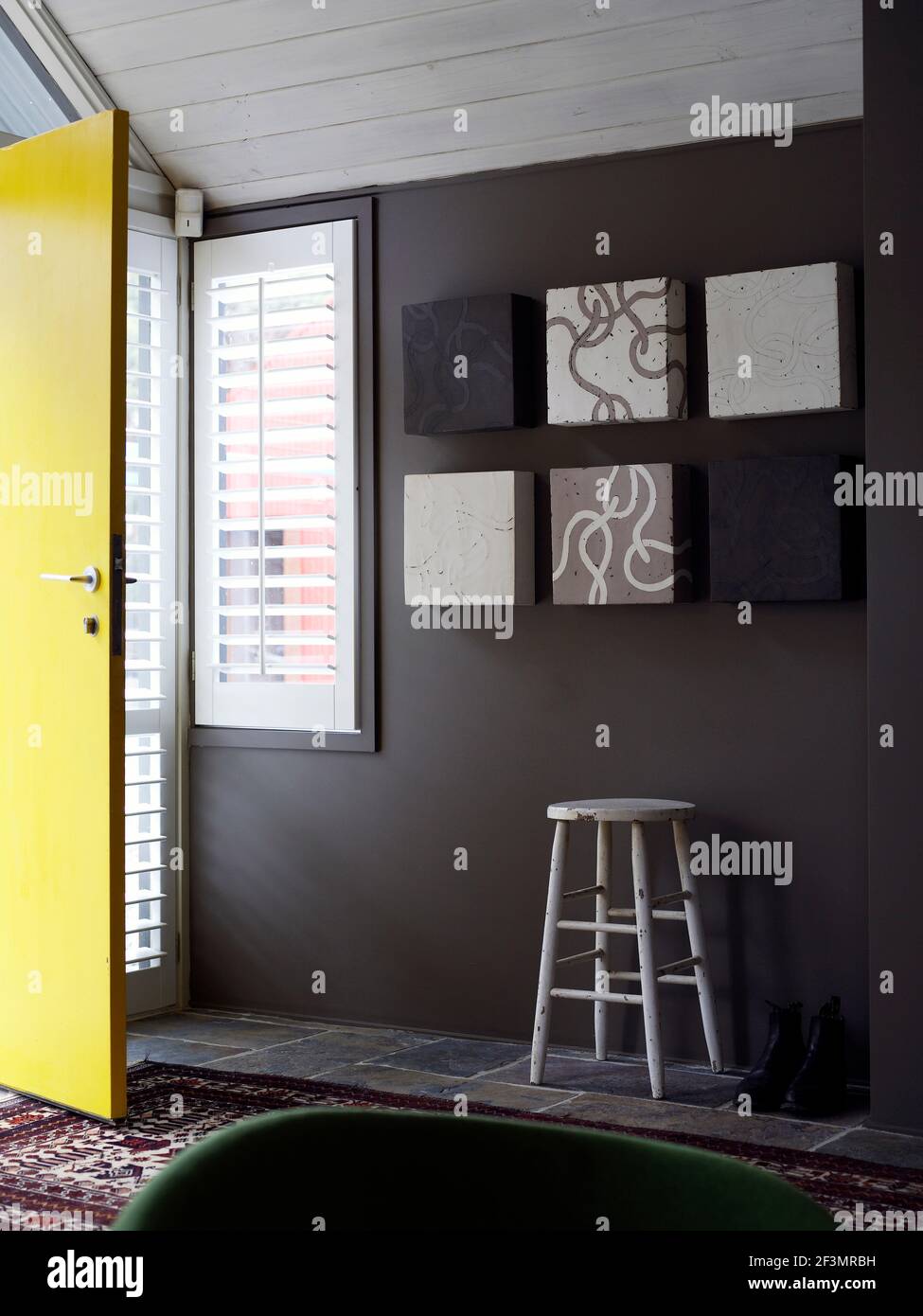 Artwork above stool in entrance of Australian home Stock Photo - Alamy