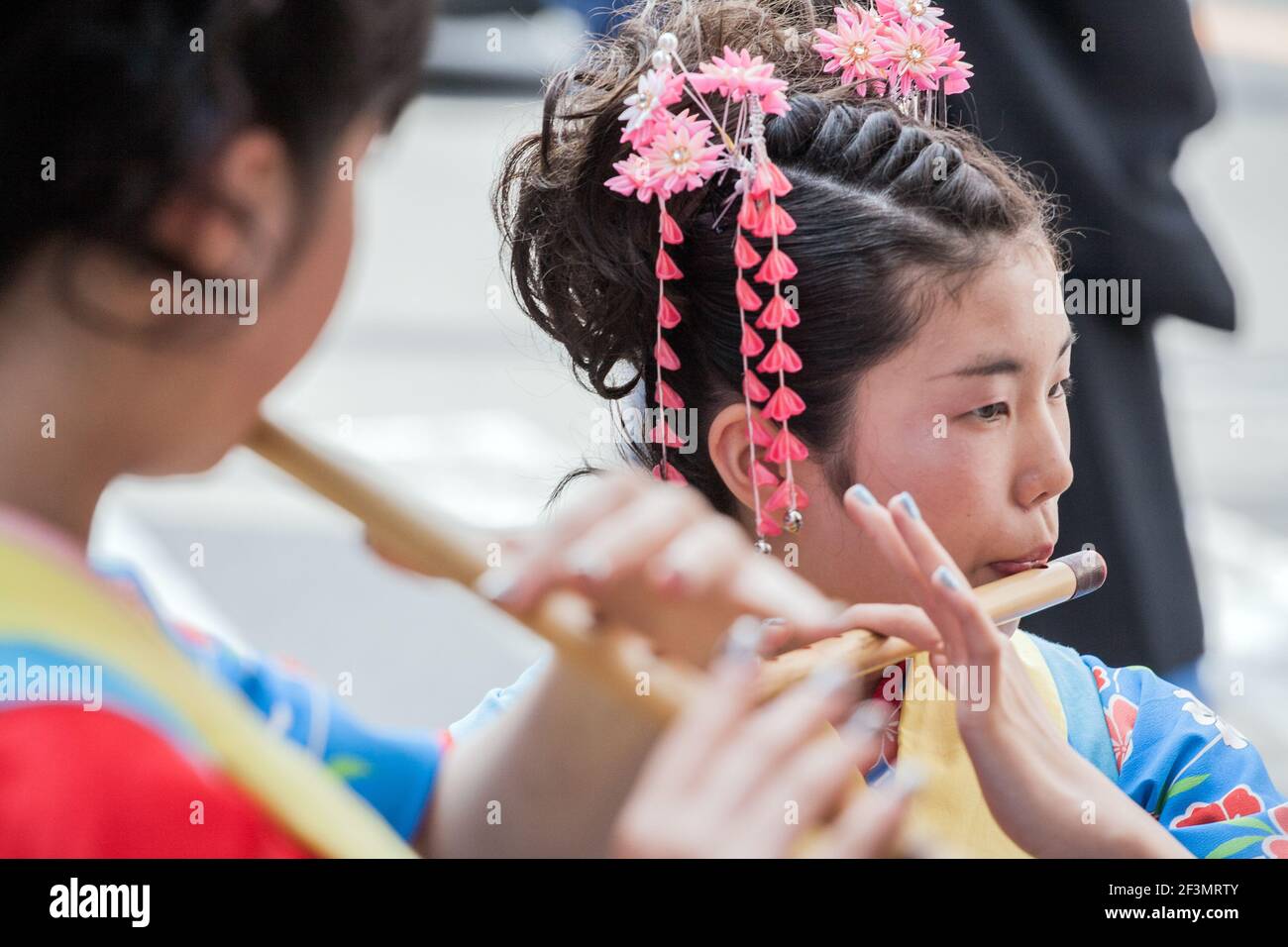 Young Japanese females playing flutes performing at the annual Yayoi ...