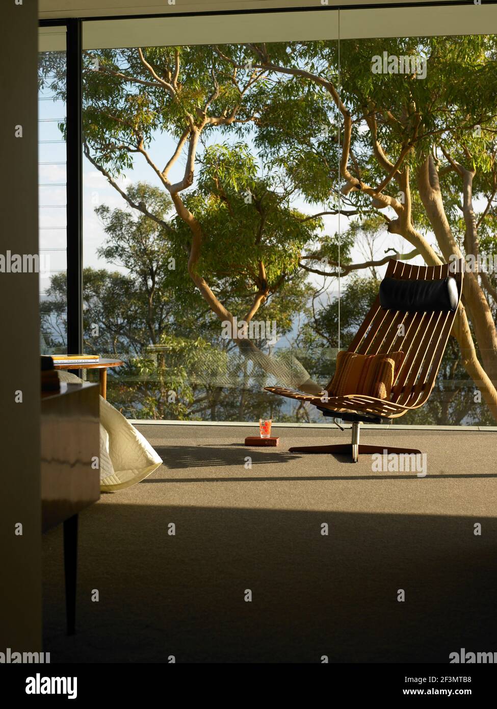 Wooden chair in front of window in Palm Beach home, Australia Stock ...