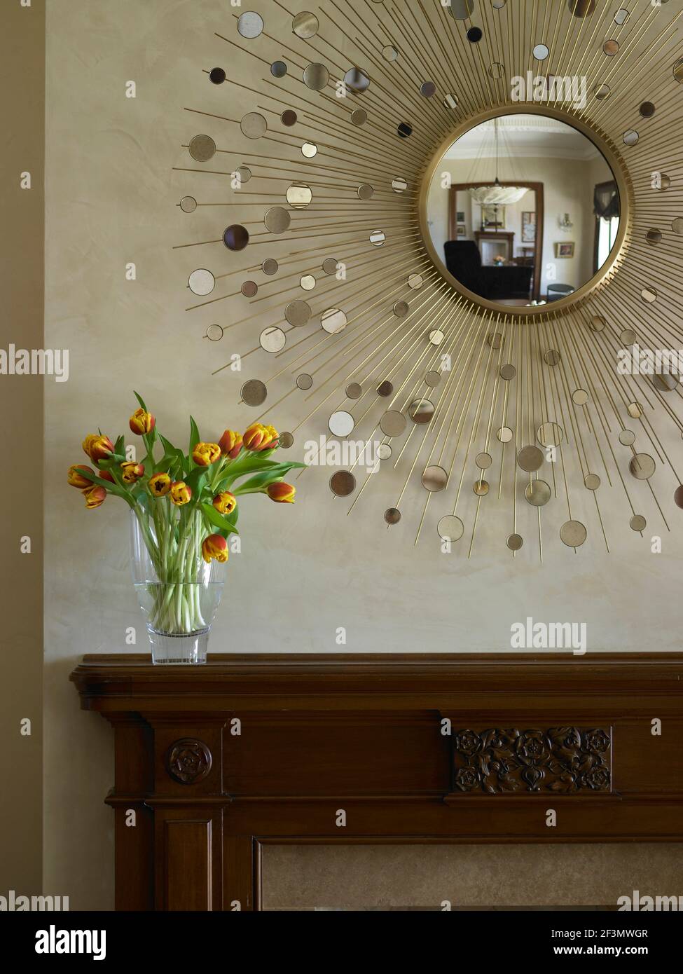 Sunray style mirror above traditional wooden fireplace, Australia Stock ...