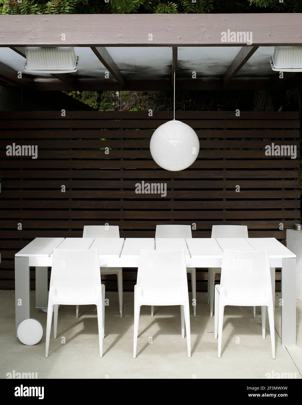 Table and chairs on shaded terrace of USA home Stock Photo - Alamy