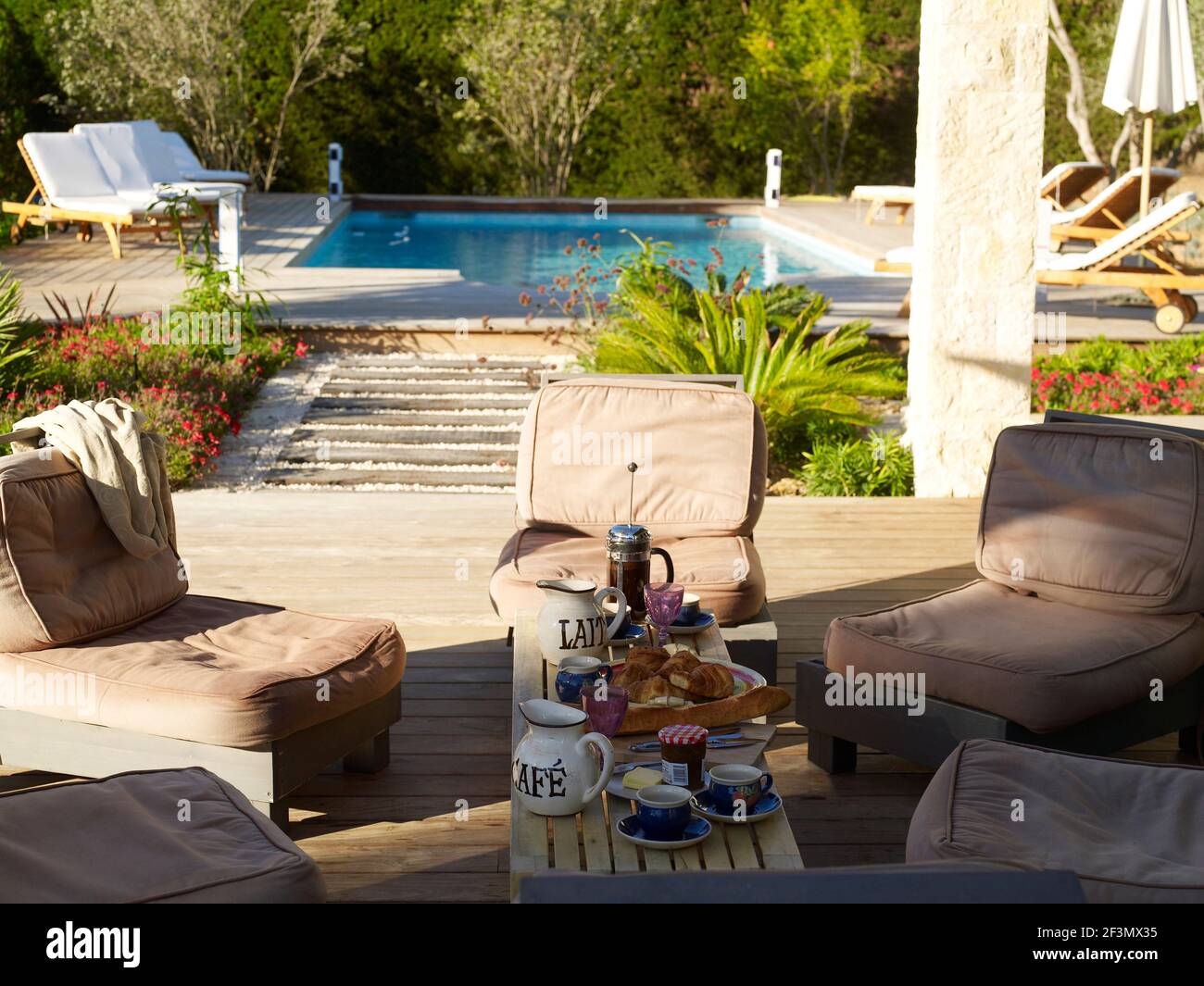 Seating on patio outside French home Stock Photo - Alamy