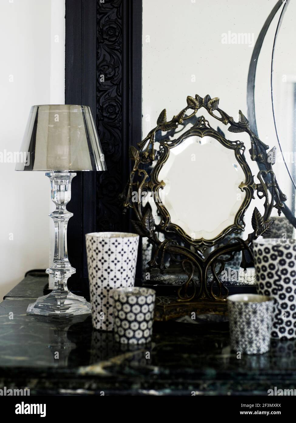 Black and white beakers arranged on fireplace mantelpiece in French ...
