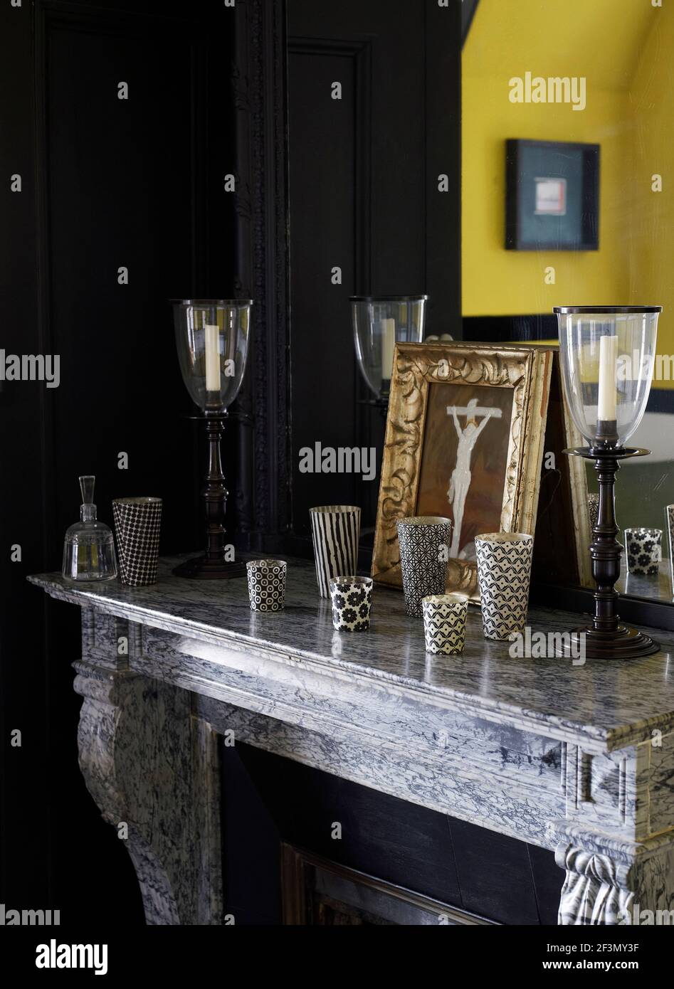 Black and white beakers arranged on fireplace mantelpiece in French ...