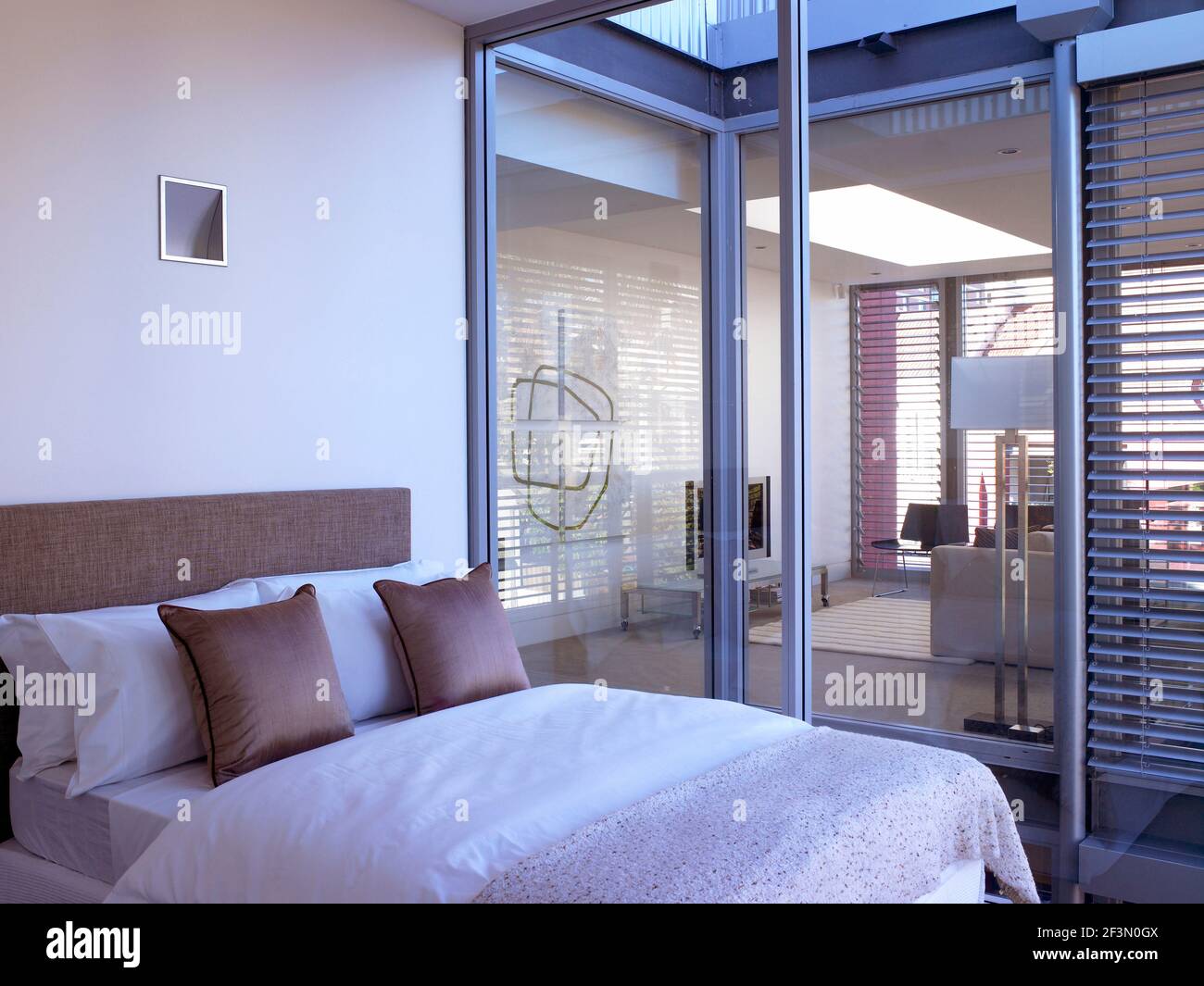 Double bed in bedroom with view to living room, Australia Stock Photo ...