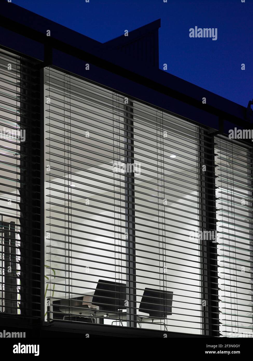 Exterior of modern house with view through window with venetian blinds ...
