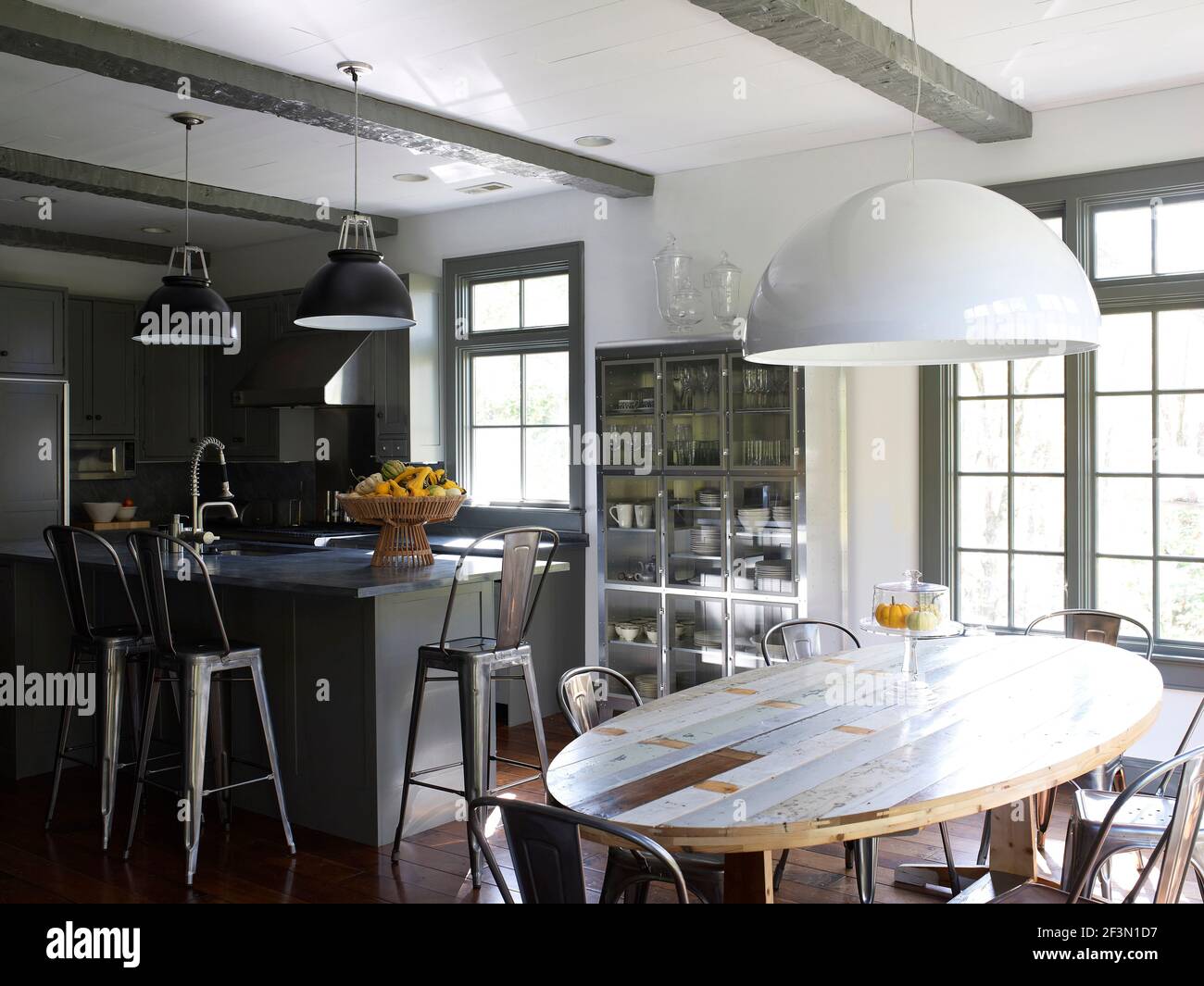 Table and chairs in spacious open plan kitchen in USA home Stock Photo ...