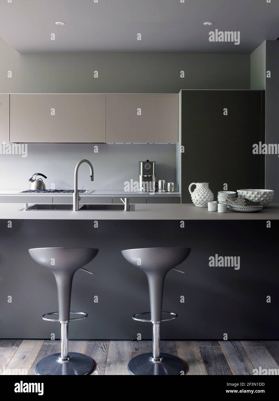 Bar stools at breakfast bar in grey kitchen in USA home Stock Photo - Alamy