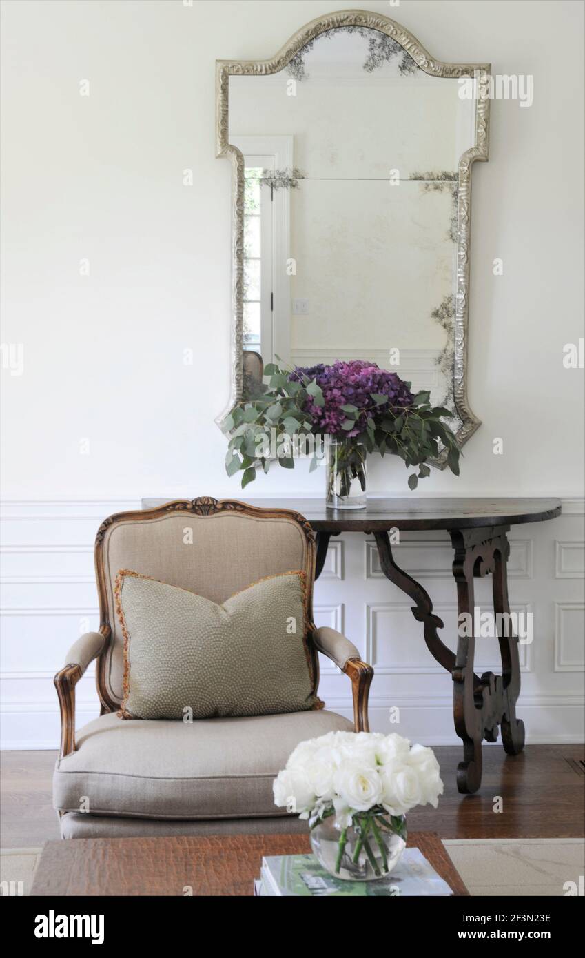 Armchair and mirror with demi-lune table in living room in Shelley ...