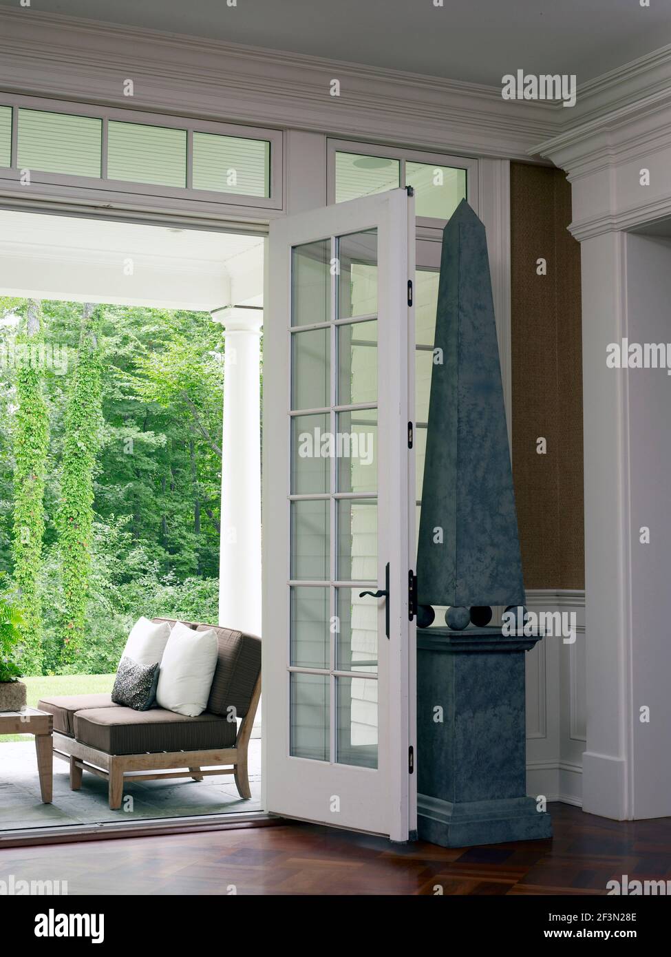 View through doorway to terrace furniture in traditional US home Stock ...
