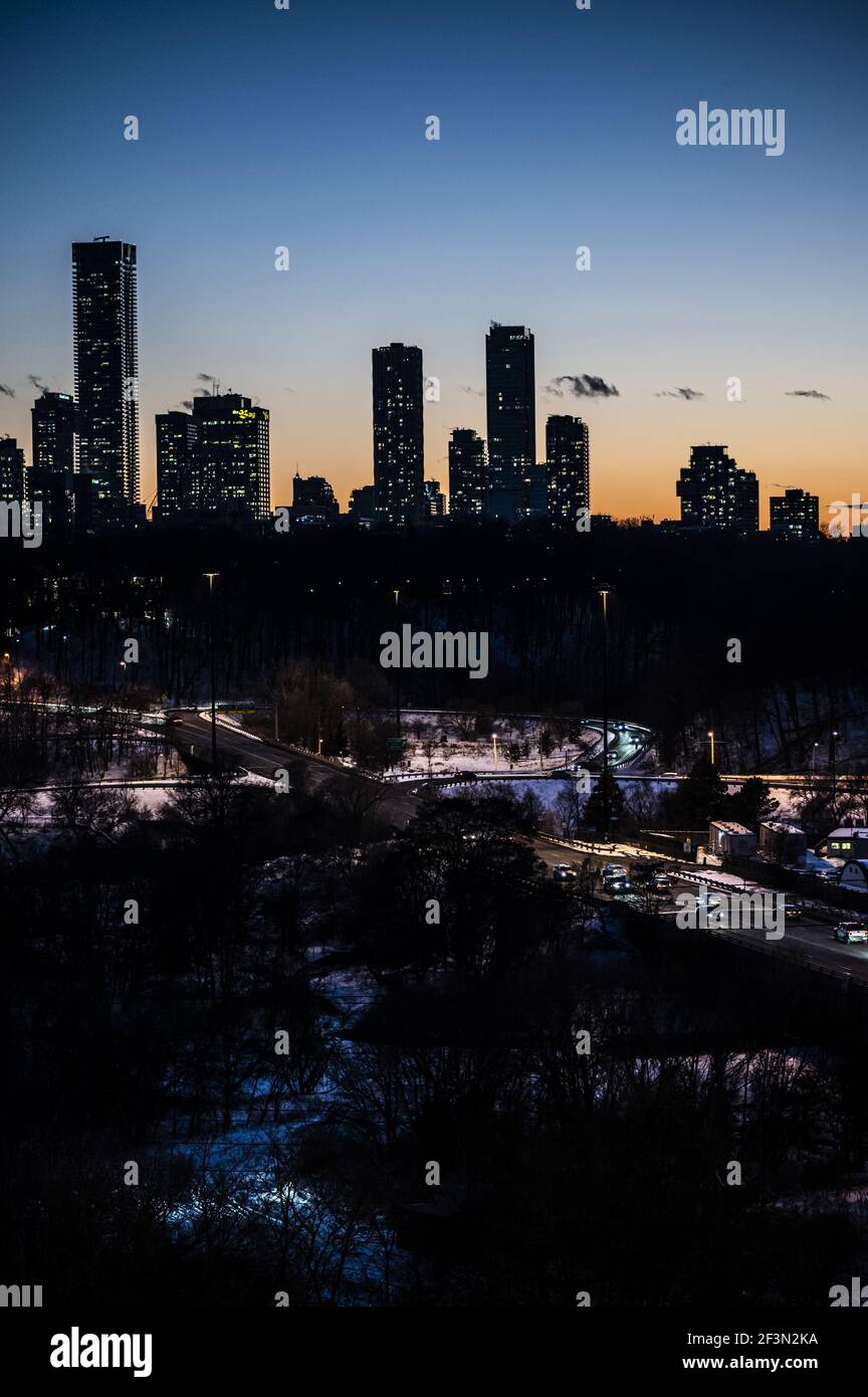 A majestic view of an urban skyline with illuminated high-rise ...