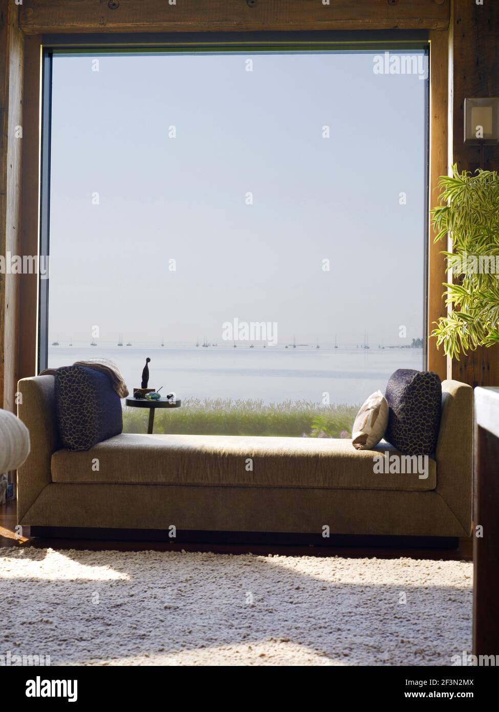 Seating in front window with view to river in USA home Stock Photo - Alamy