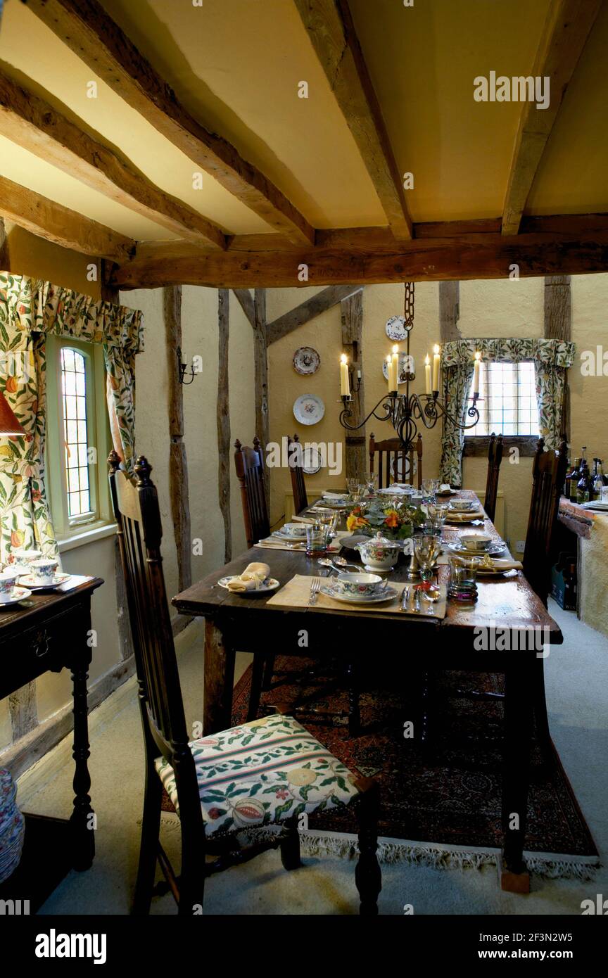 Traditional beamed Tudor dining room with set dinner table Stock Photo ...