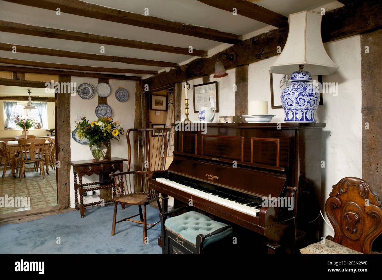 Beamed Tudor entrance hall with piano Stock Photo - Alamy