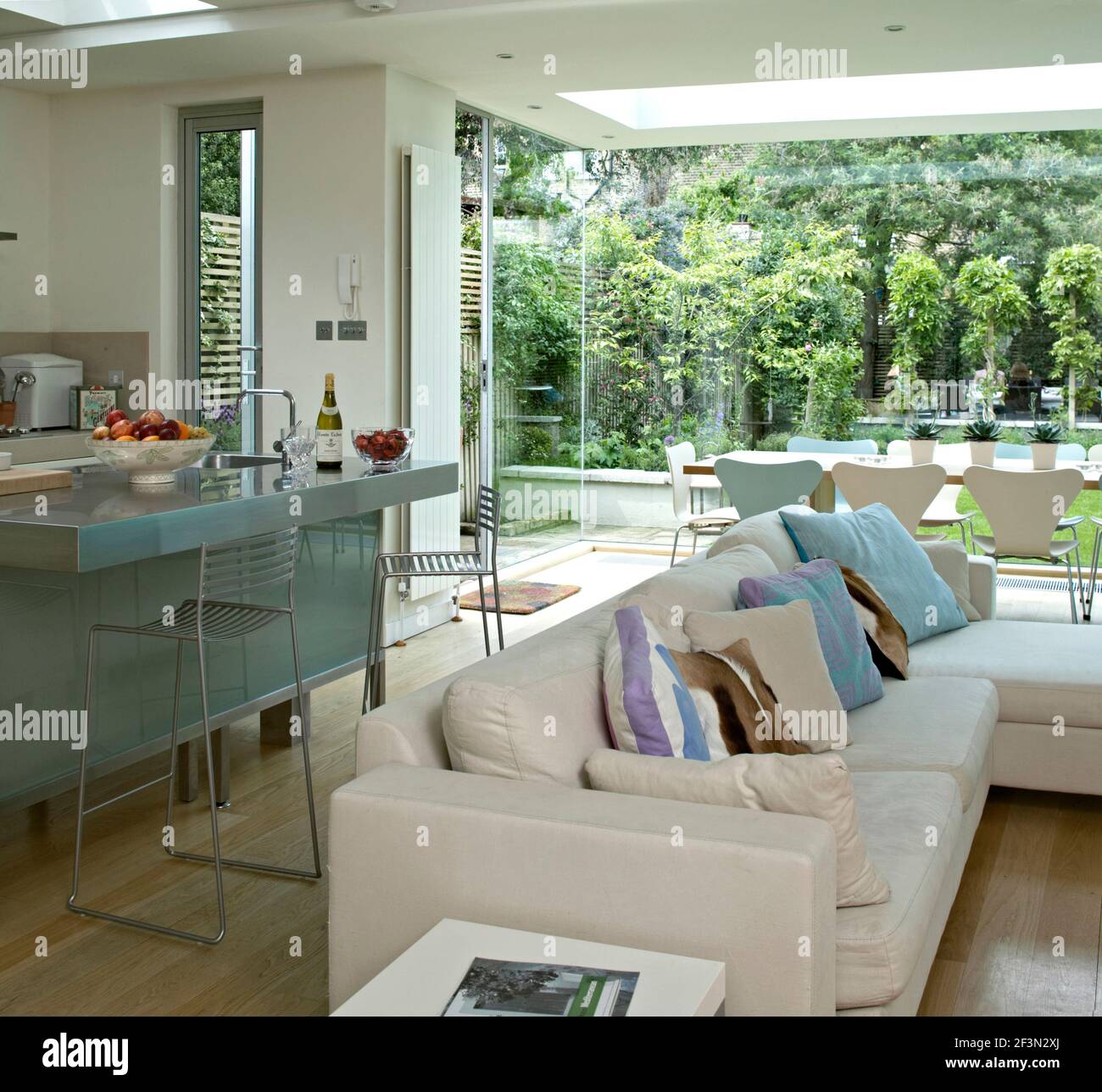 Breakfast bar in open plan kitchen with back to sofa Stock Photo Alamy