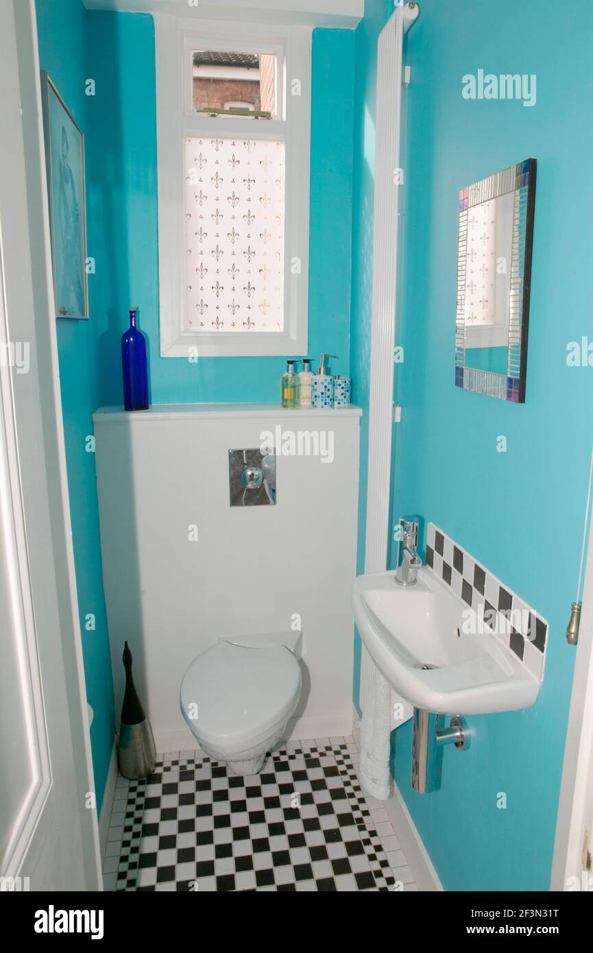 A modertn cloak room/rest room with blue wall and tiled floor Stock ...