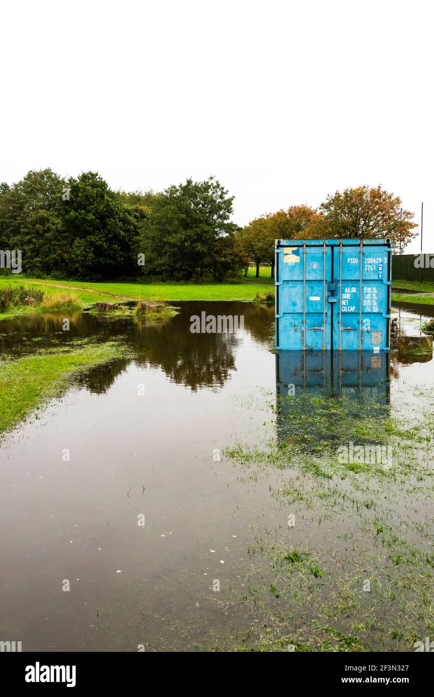 An old shipping container on flooded land Stock Photo - Alamy