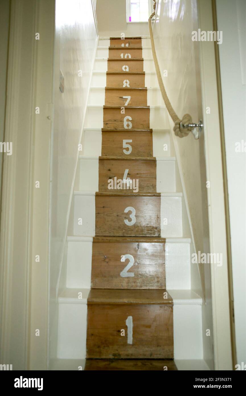 Staircase with numbered steps and rope banister Stock Photo - Alamy