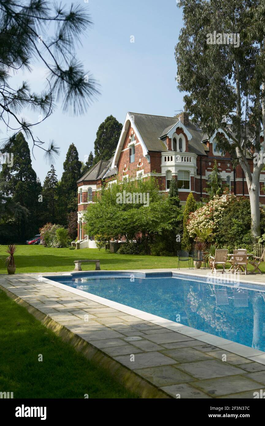 Exterior of red brick country house with outdoor swimming pool Stock ...