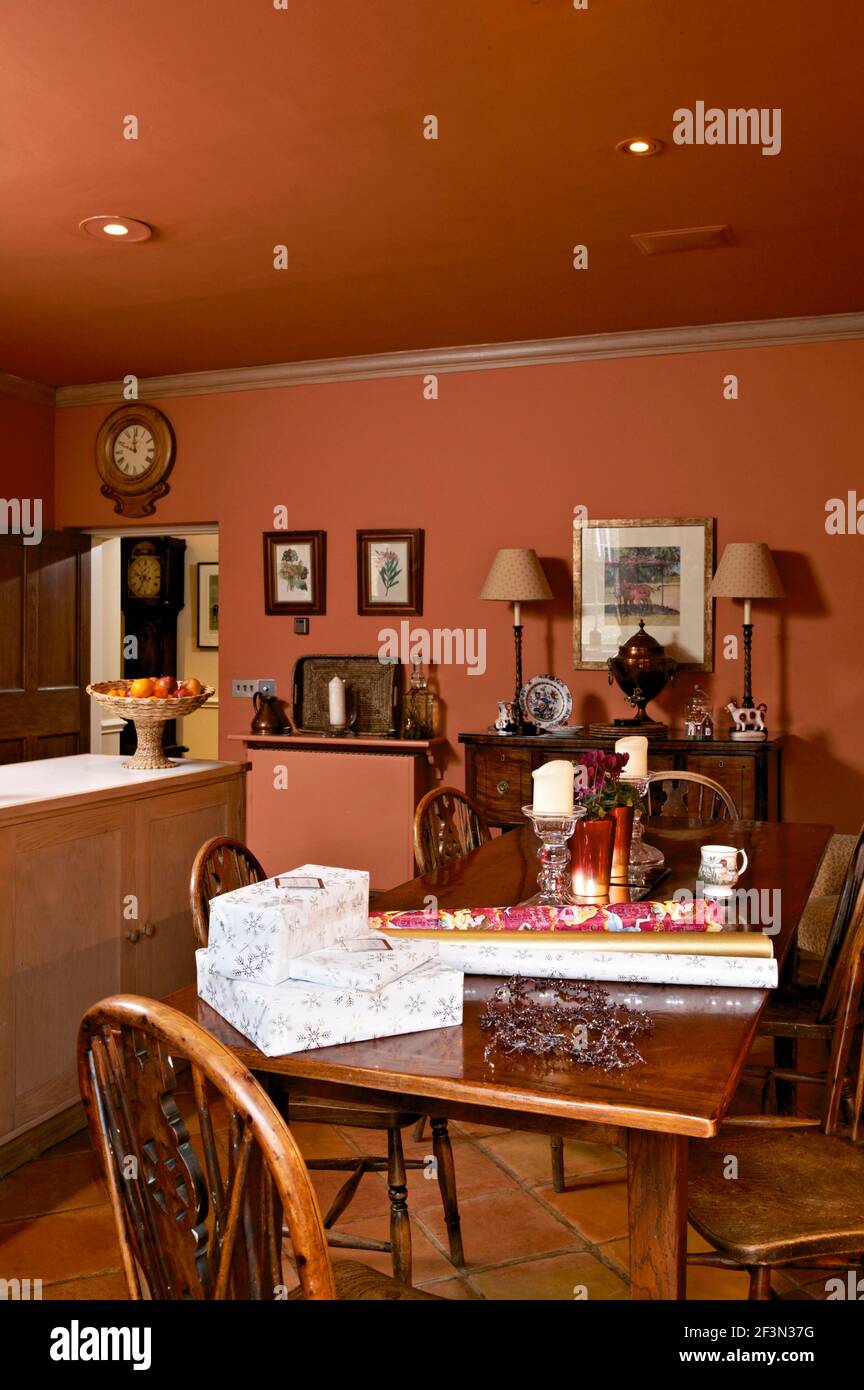 Terracotta kitchen with dining table and chairs Stock Photo - Alamy