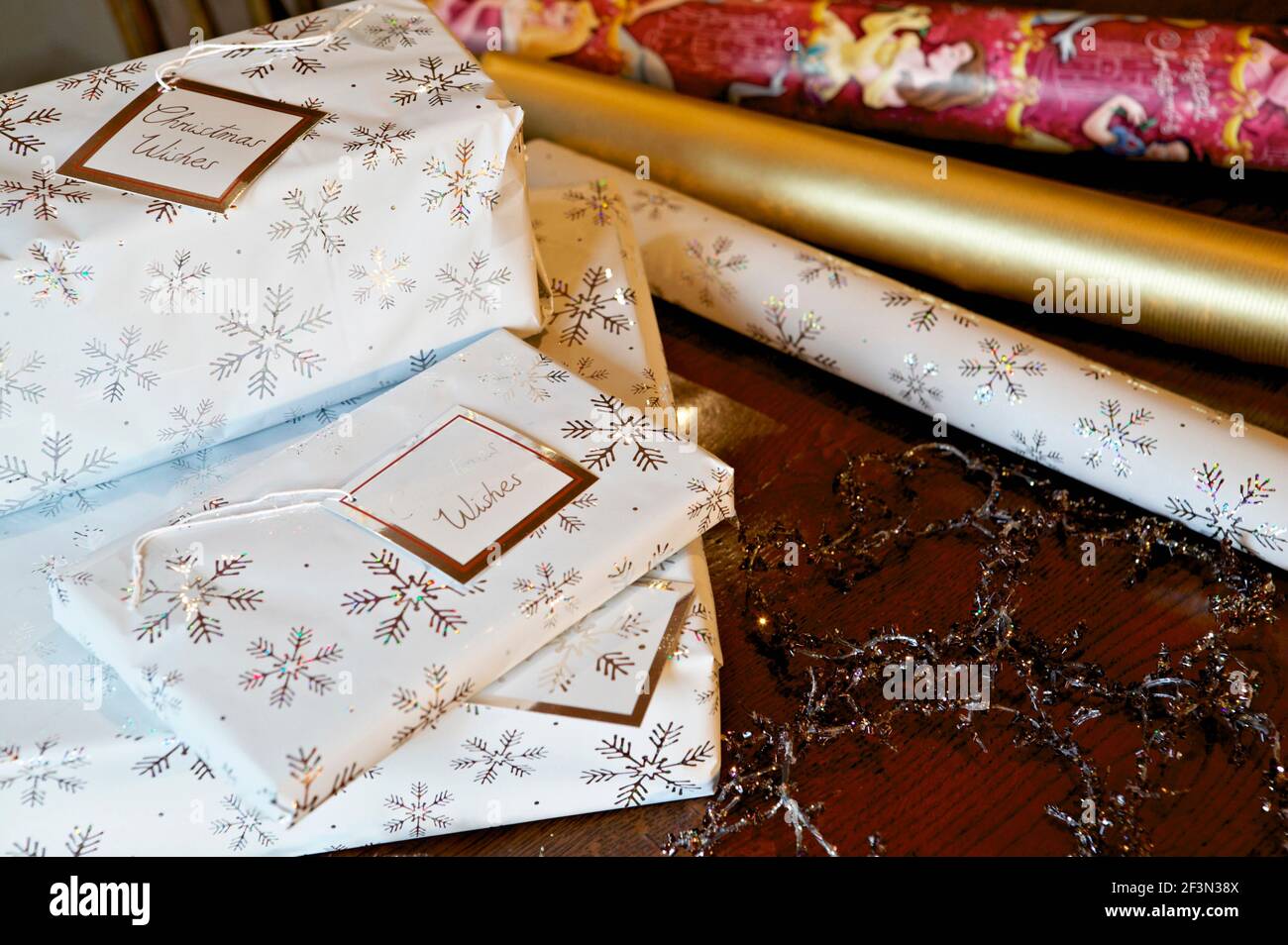 Christmas presents wrapped in silver paper Stock Photo - Alamy