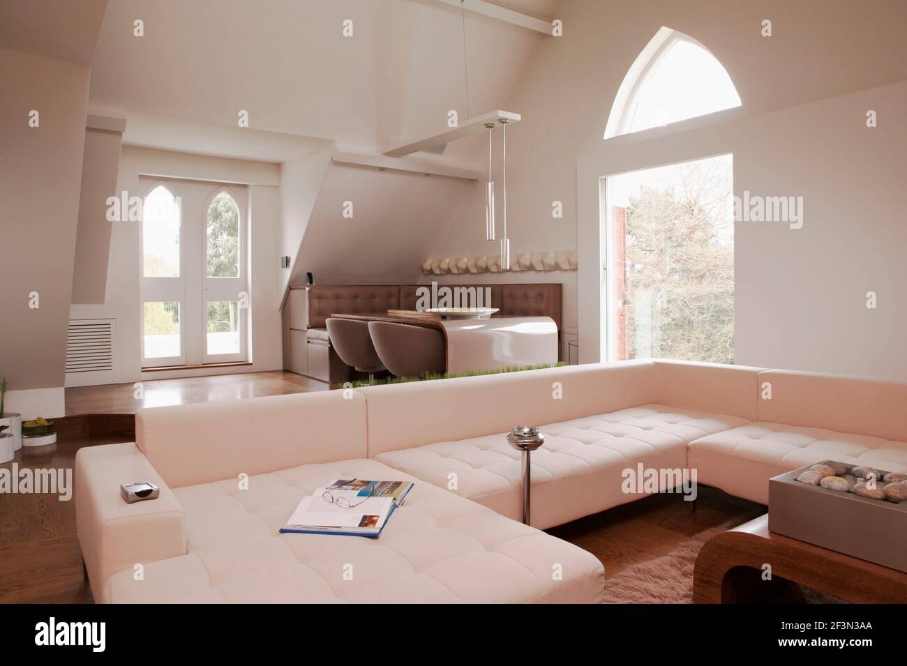 Upholstered sofa seating area in front of dining table and chairs Stock ...