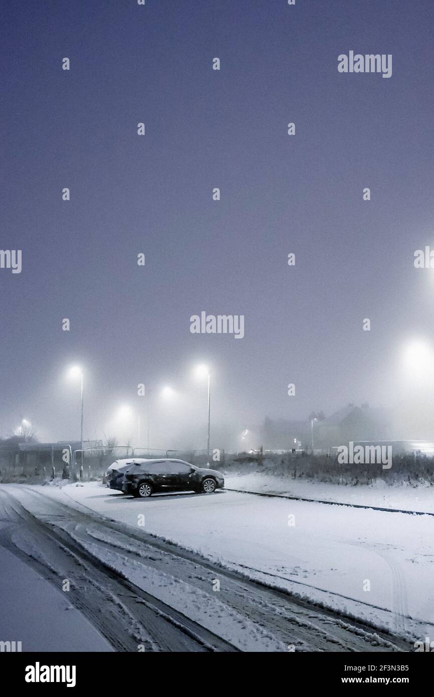 Cars parked under street lights in a snow storm, in Consett, County ...
