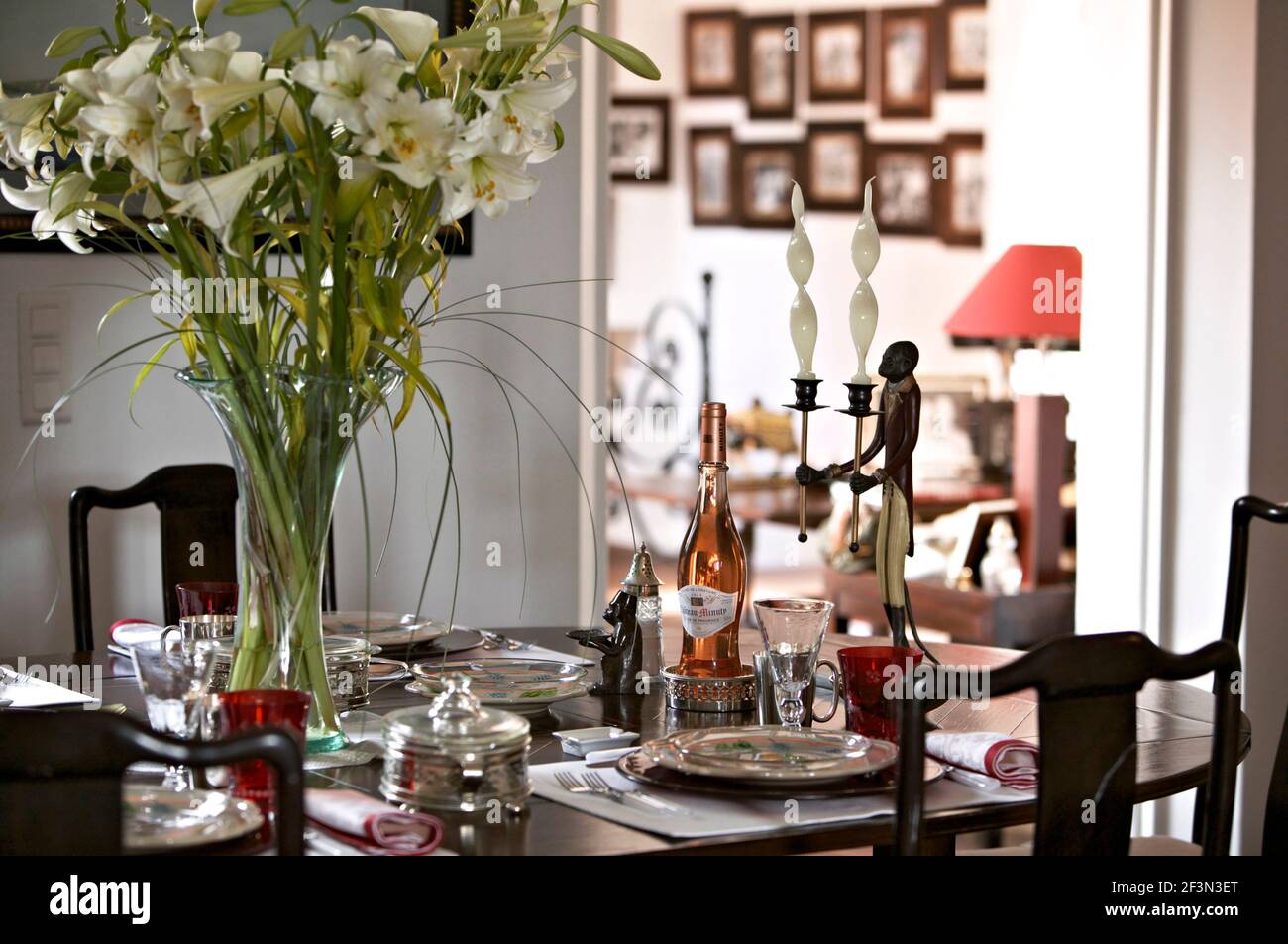 Table laid for dinner with flower arrangement centrepiece Stock Photo ...