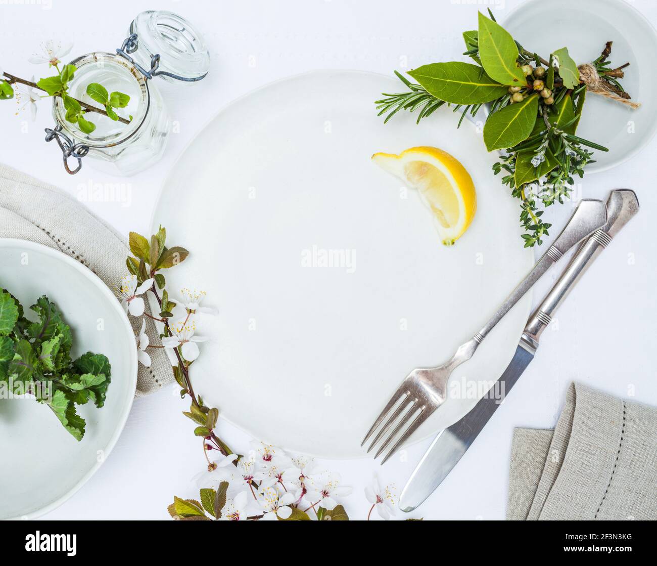 table setting with a lemon wedge on an empty plate Stock Photo - Alamy