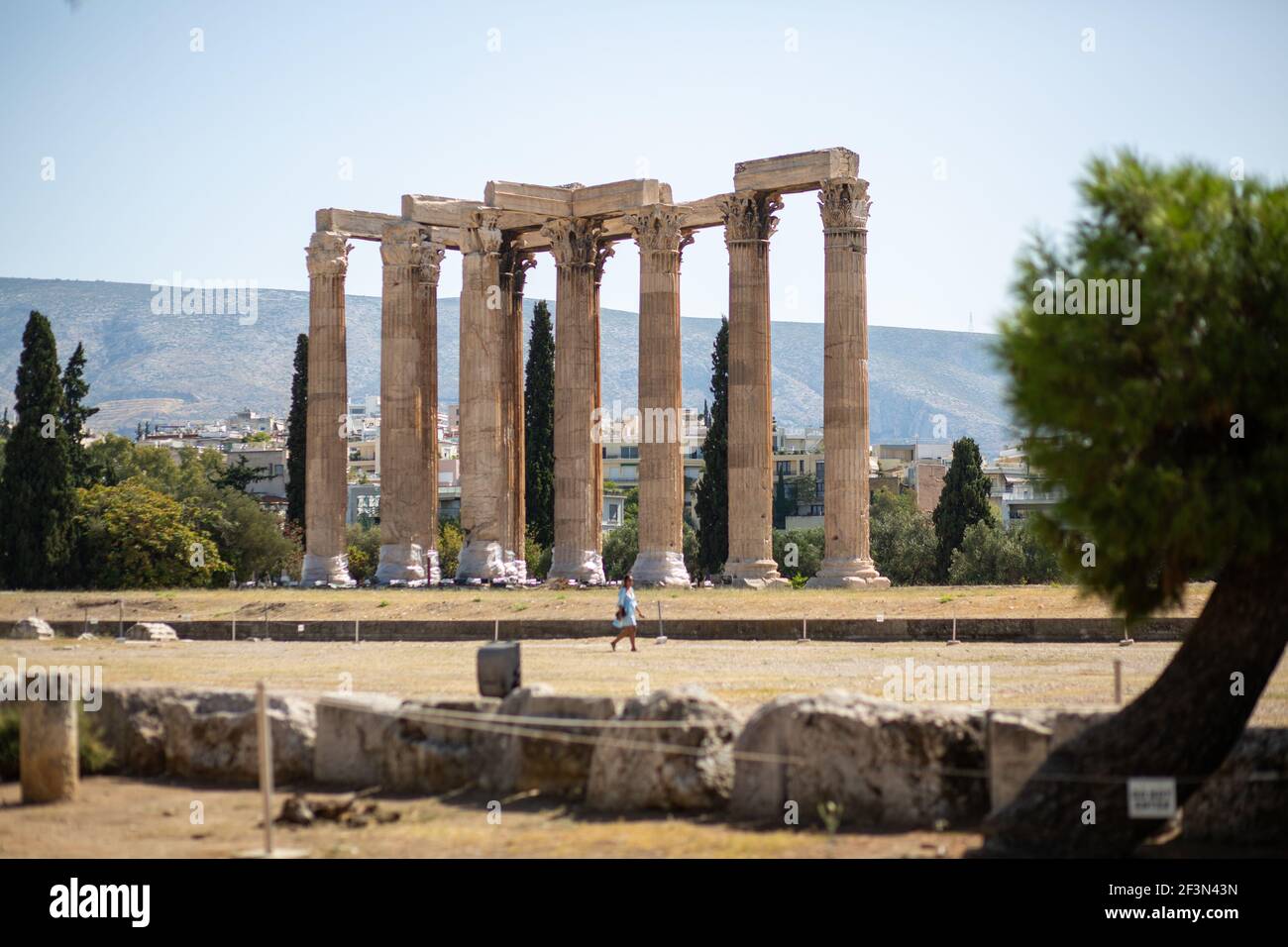 The ruins of the Temple of Olympian Zeus under the sunlight and a blue ...