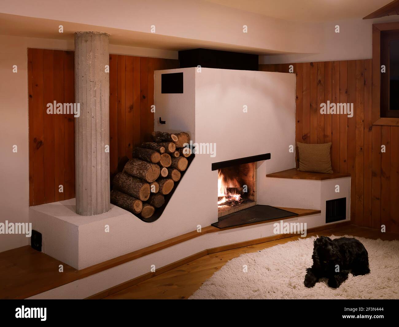 Fireplace with log storage in wood panelled living room, UK home Stock ...