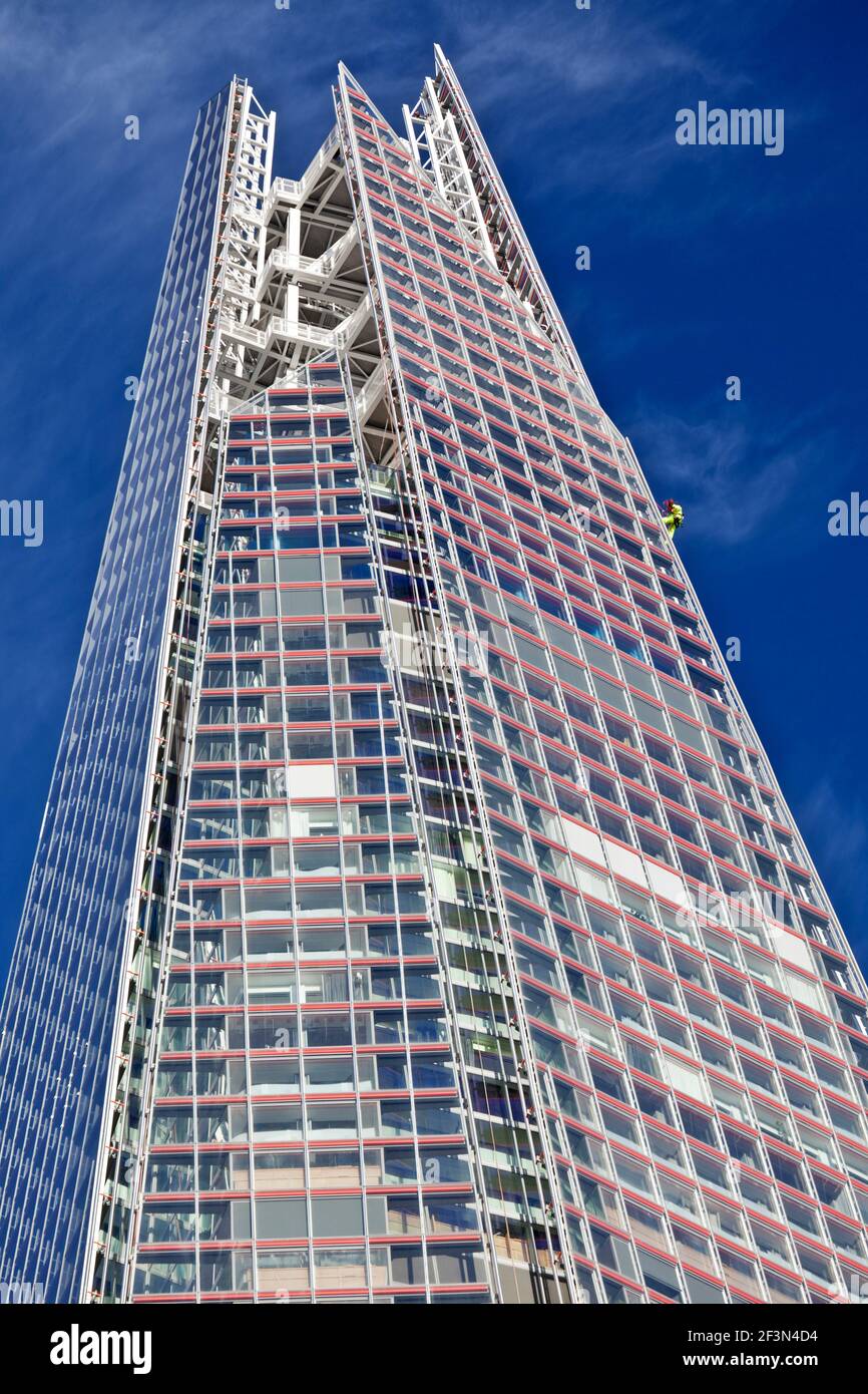 A maintenance worker scales the spire of the Shard, London Bridge ...
