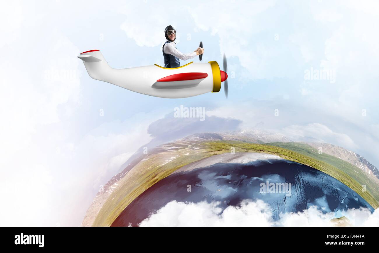 Aviator in leather helmet driving small plane Stock Photo - Alamy