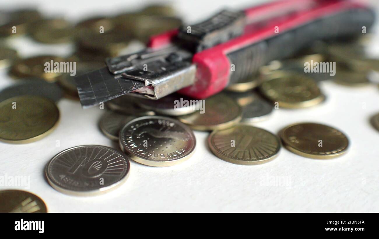 3D illustration - metal coins and cutter blade Stock Photo - Alamy