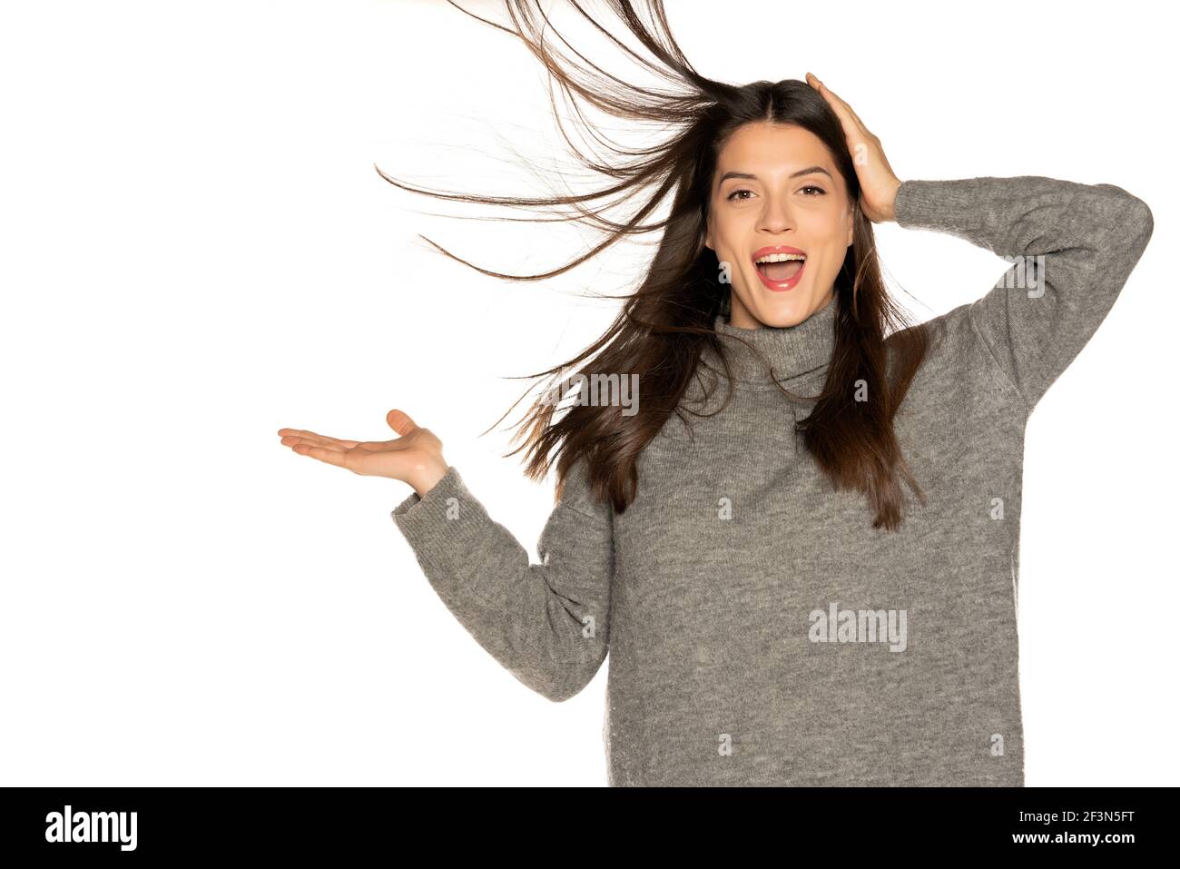 young beautiful woman holding imaginary object on her hand on white ...