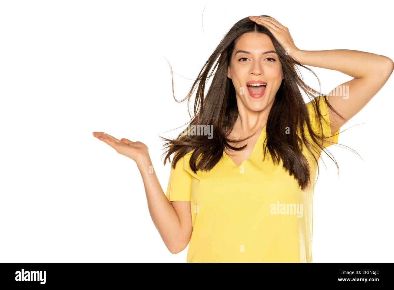 young beautiful woman holding imaginary object on her hand on white ...