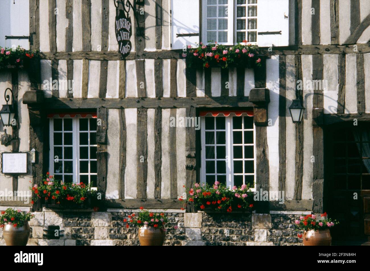 A typical traditional timber framed inn, or hotel, with flowers in the ...