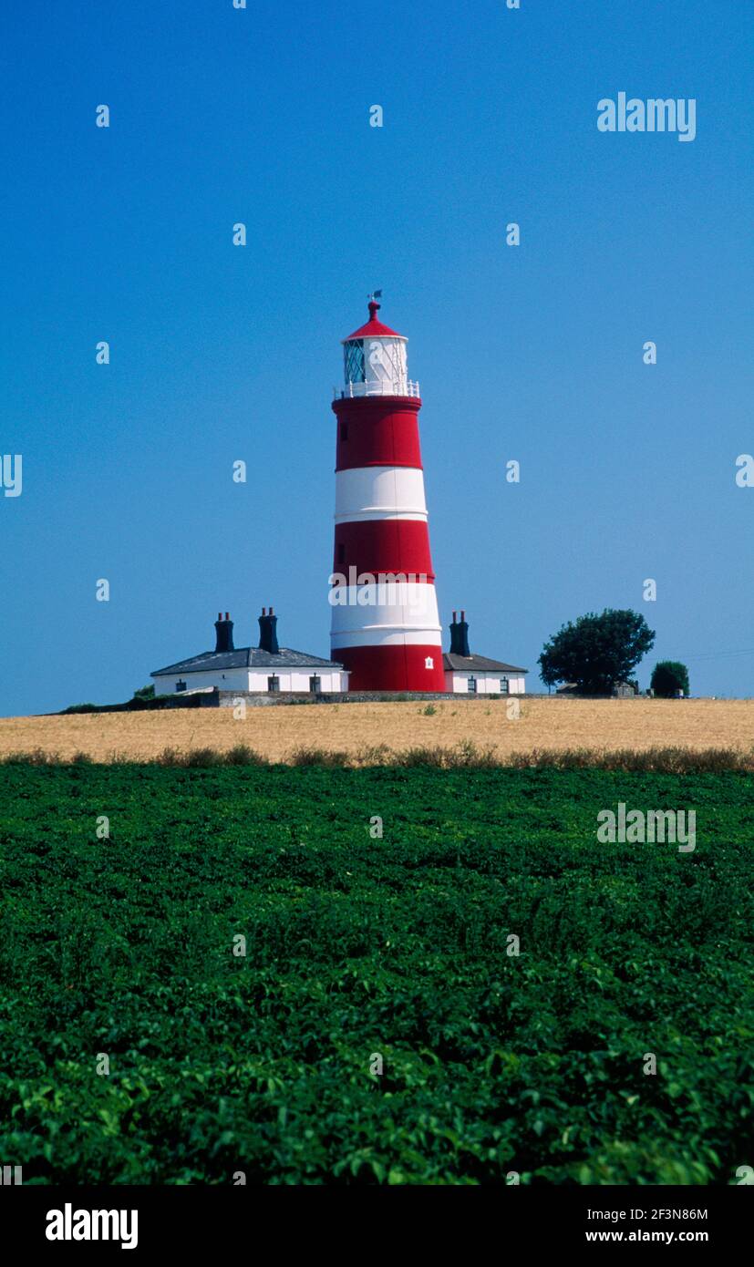 Lighthouse. Red and white stripes. Green field. Yellow crops. Two white ...