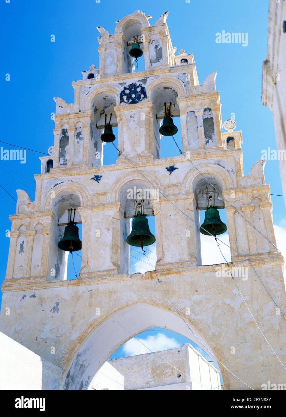 Looking up at church bell tower with five bells and white washed walls ...