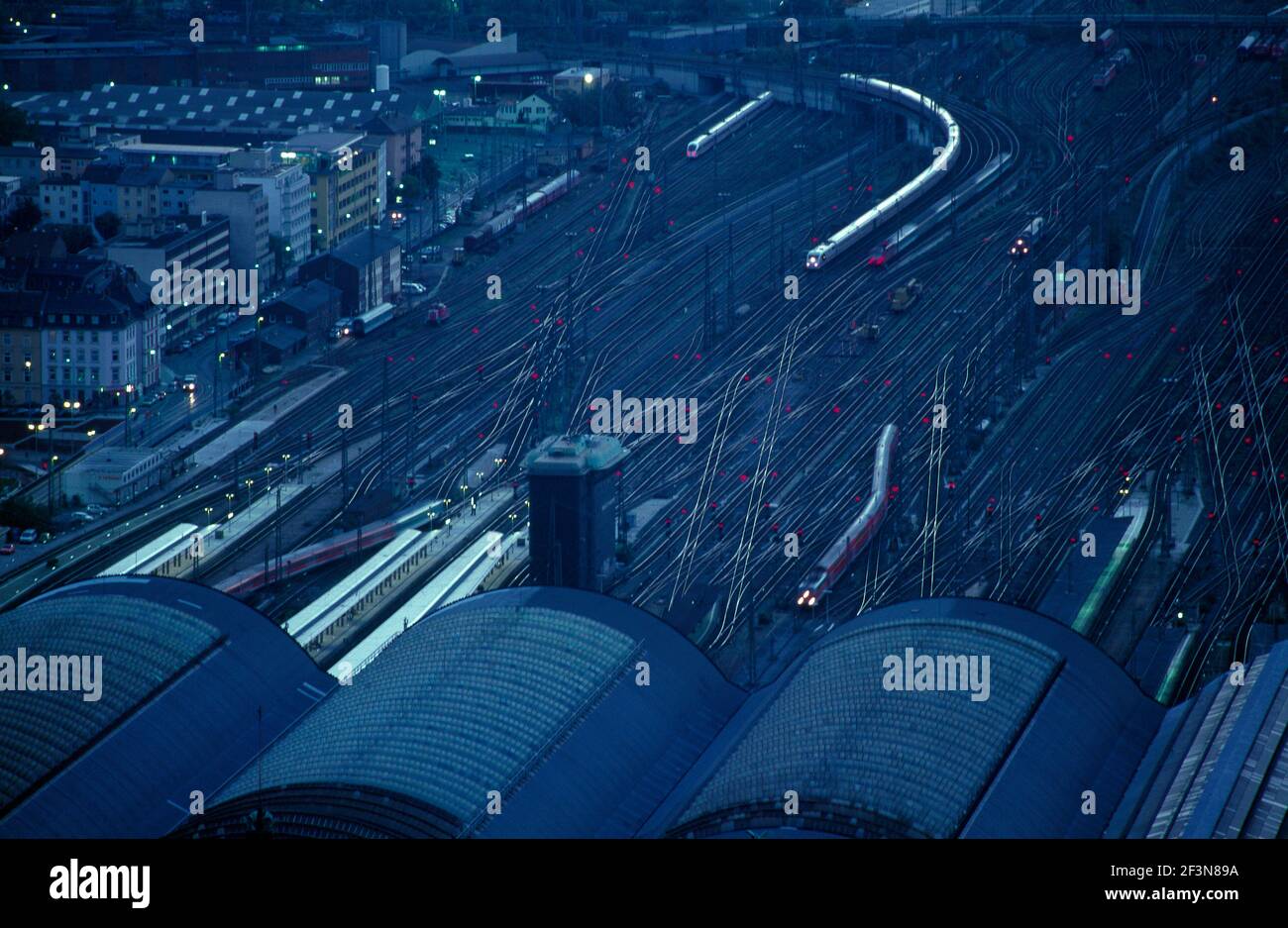 View over main station train tracks. Grey, blue light. Trains moving ...