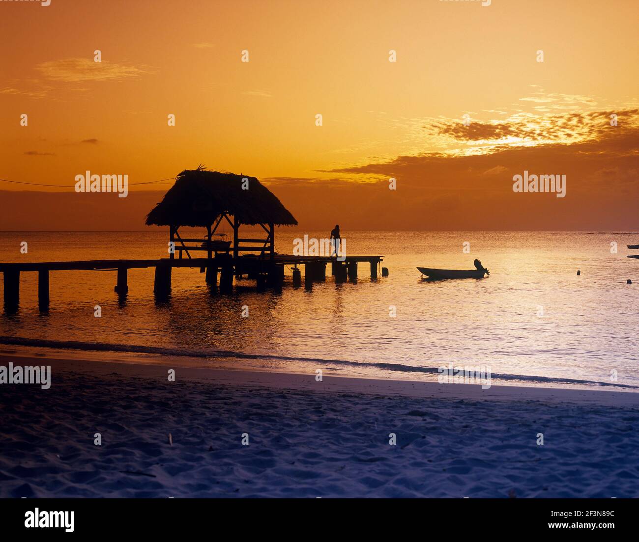 Pigeon Point jetty at sunset. Orange sky. Boat moored Stock Photo - Alamy