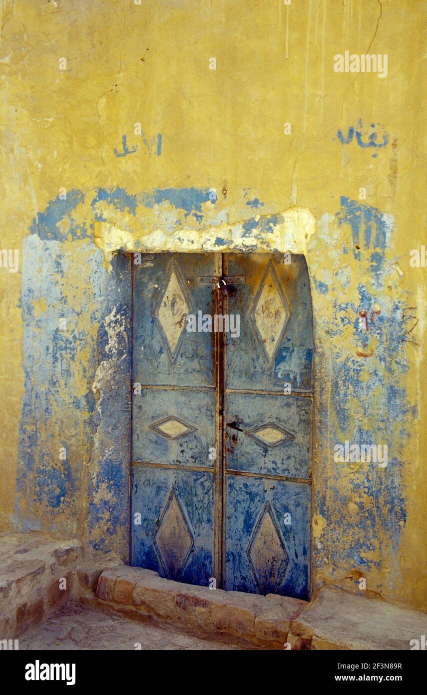 Site of medieval village. House. Peeling plaster, paint. Blue door ...