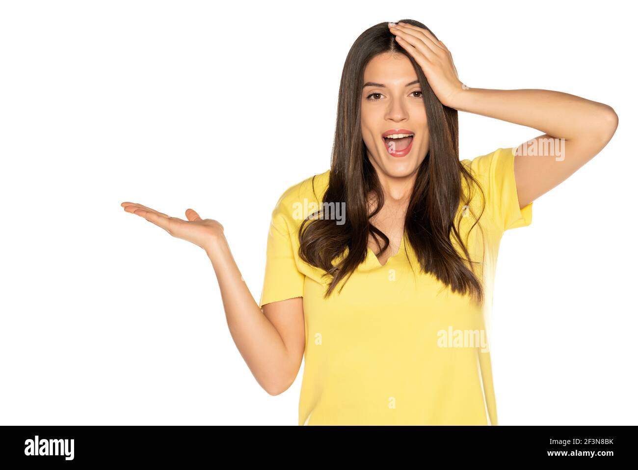 young beautiful woman holding imaginary object on her hand on white ...