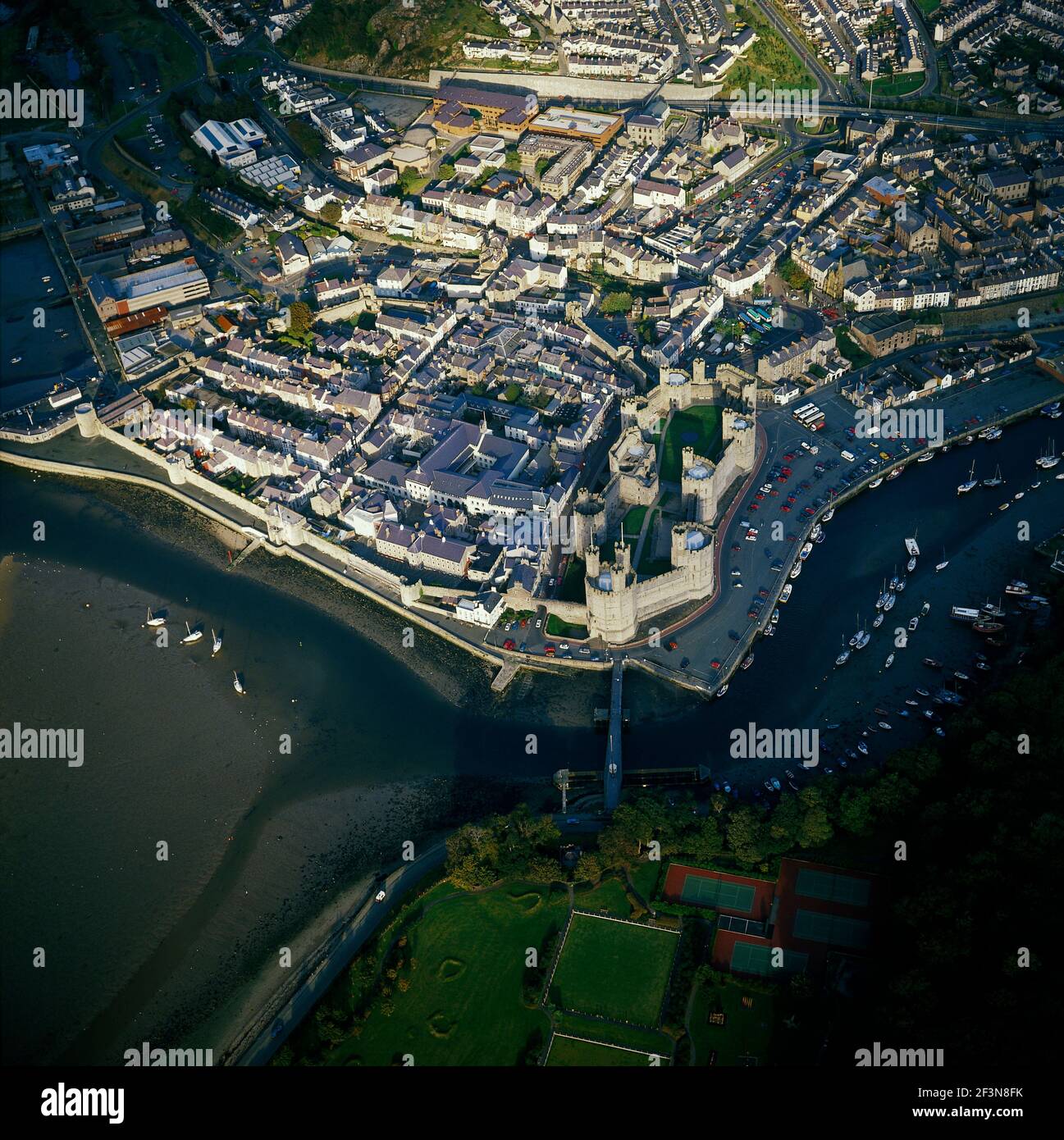 Aerial view of Caernarfon and its castle. Boats on the River Seiont ...