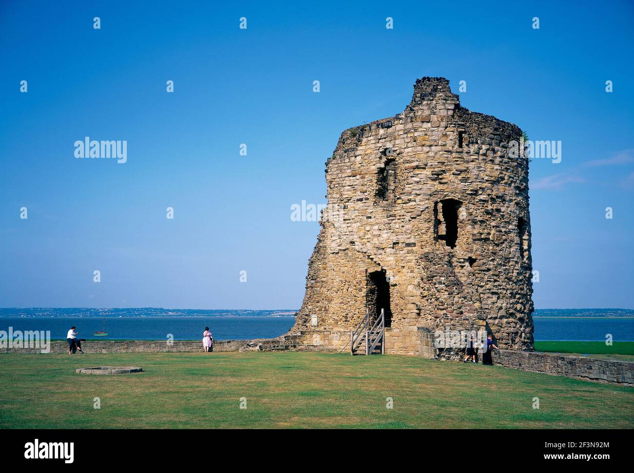 Flint Castle. Crumbling remains of old North East stone tower. Sea in ...